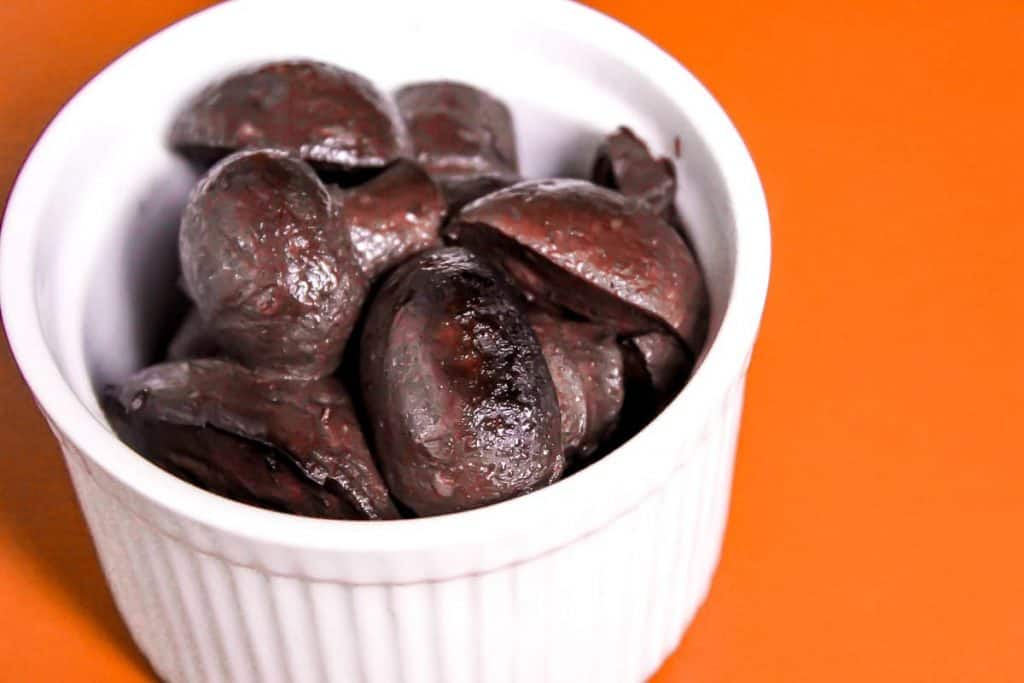 White ramekin with purple or burgundy mushrooms
